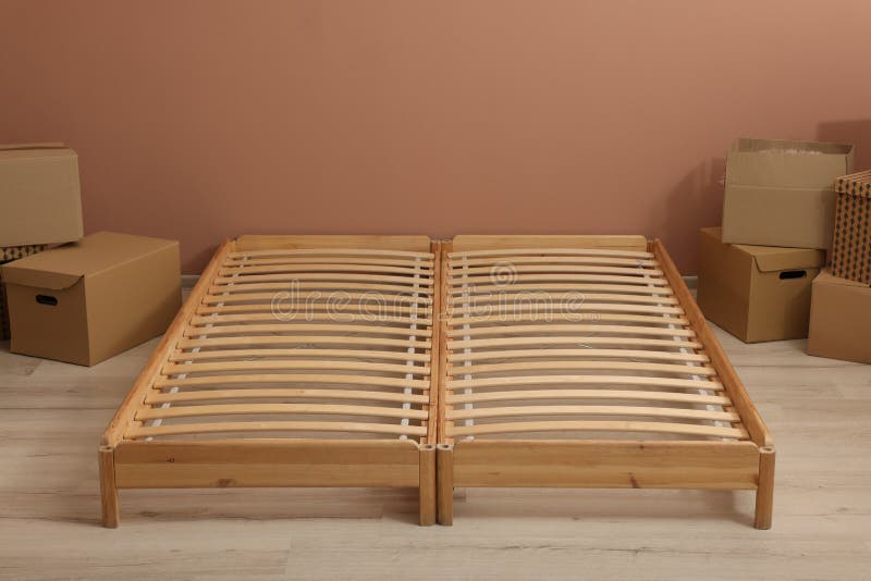 Wooden Bed Frame and Cardboard Boxes on Floor in Room Stock Photo ...