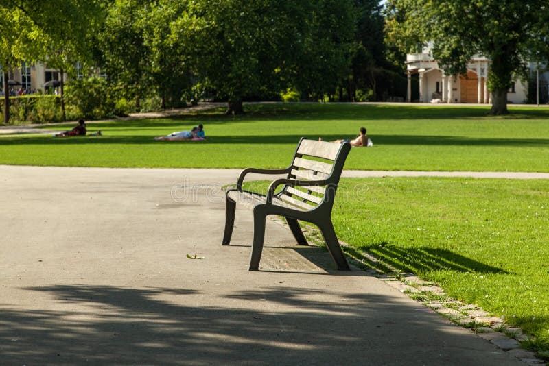 Wooden Bench Along a Concrete Path in a Park in Rotterdam, the ...