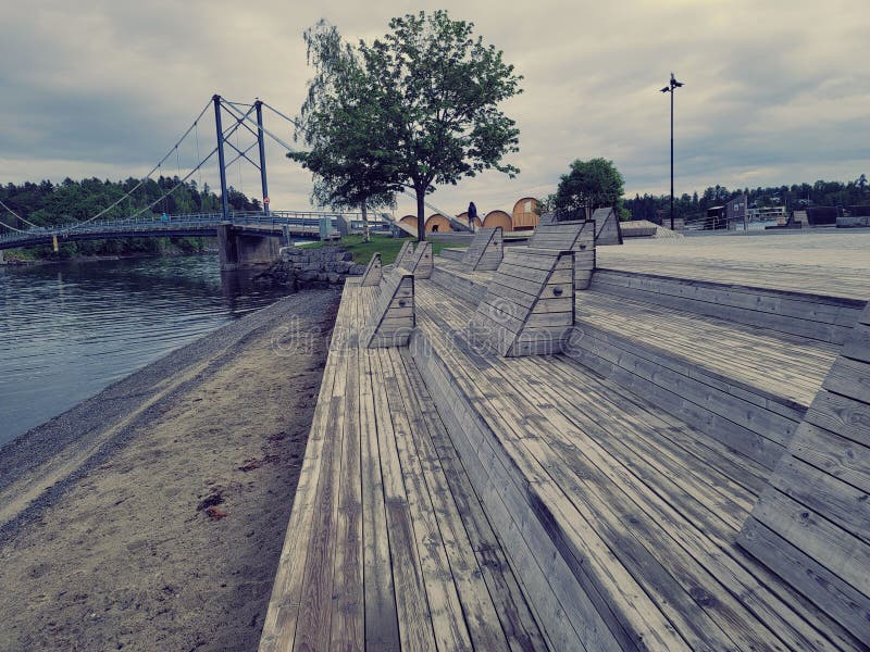 Wooden Bench Along the Public Park River with the Bridge View, Stock ...