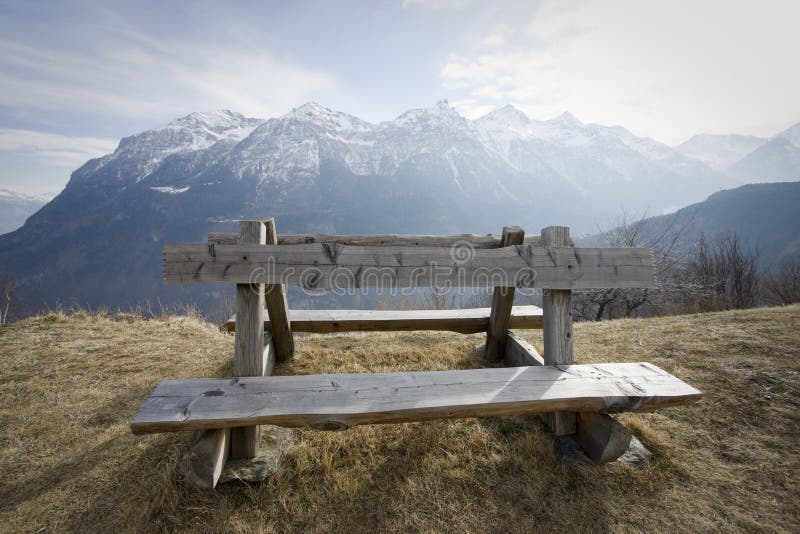 Wooden bench on the alps stock image. Image of bench - 23791655
