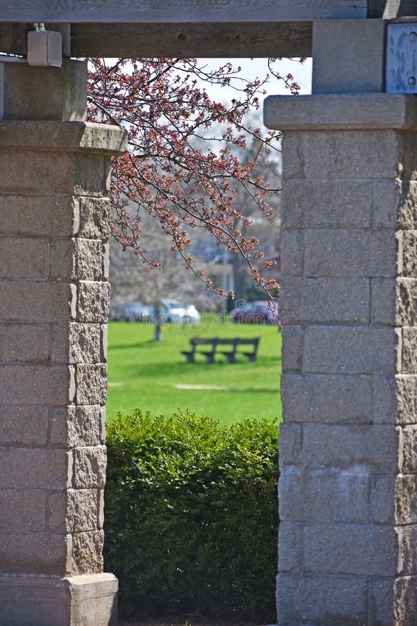 Wooden Bench As Seen through Two Posts Stock Photo - Image of green ...