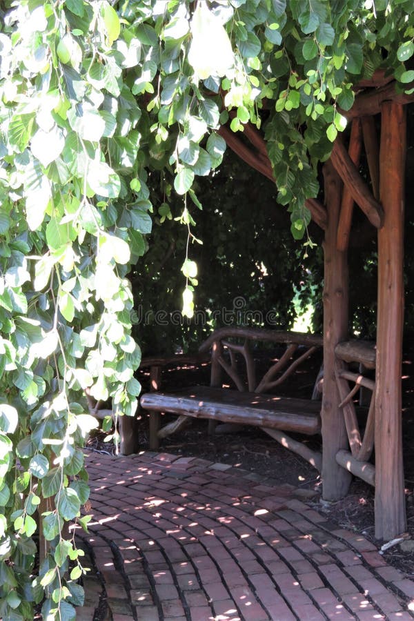 Wooden Bench on Brick Path Under Arbor Stock Image - Image of light ... Wooden Bench on Brick Path Under Arbor Stock Image - Image of light ...