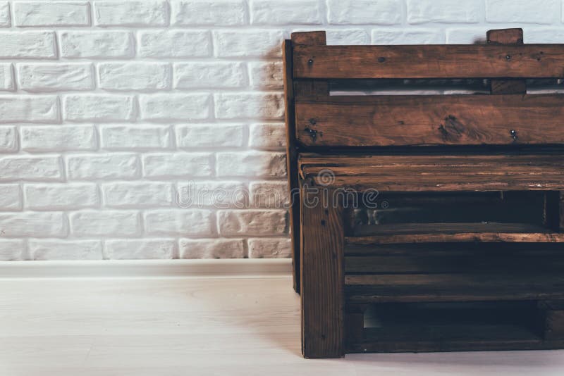 Wooden Bench of Flying Against a White Brick Wall Stock Photo - Image ...