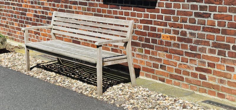 Wooden Bench in Front of a House with a Red Facade and Stock Image ...