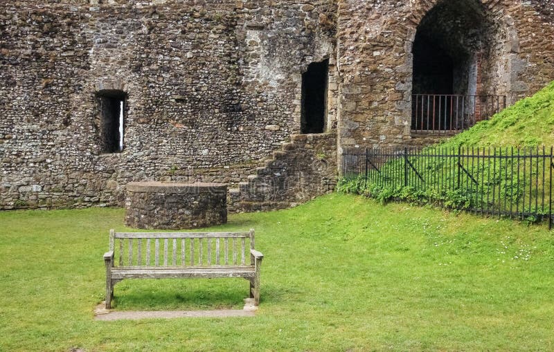 A Wooden Bench in Front of Medieval Wall Ruins Stock Photo - Image of ...