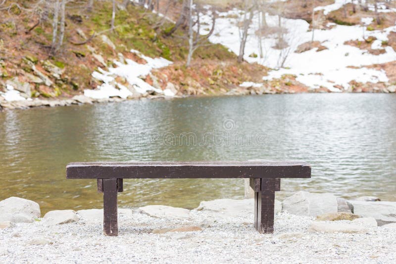 Wooden bench on the lake stock image. Image of park, brown - 53723559