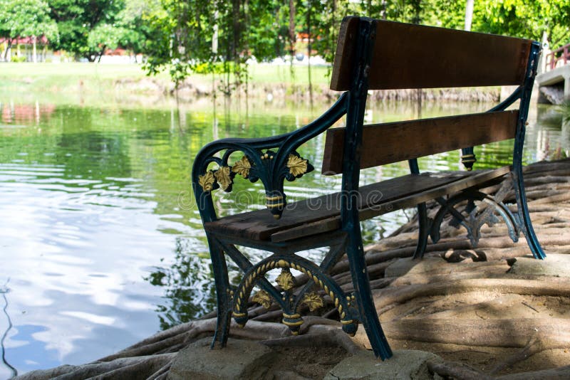 Wooden Bench Overlooking a Pond. Stock Image - Image of lake, park ...