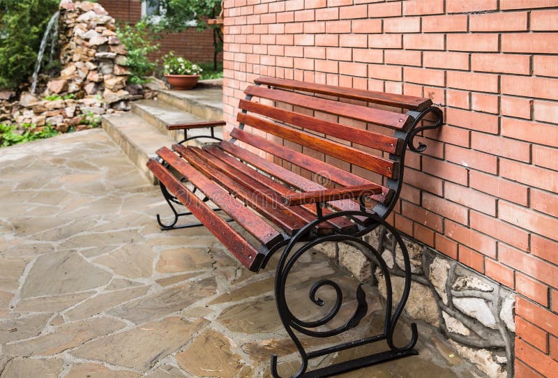 Sidewalk Scene with Wooden Bench and Brick Wall. Stock Image - Image of ...