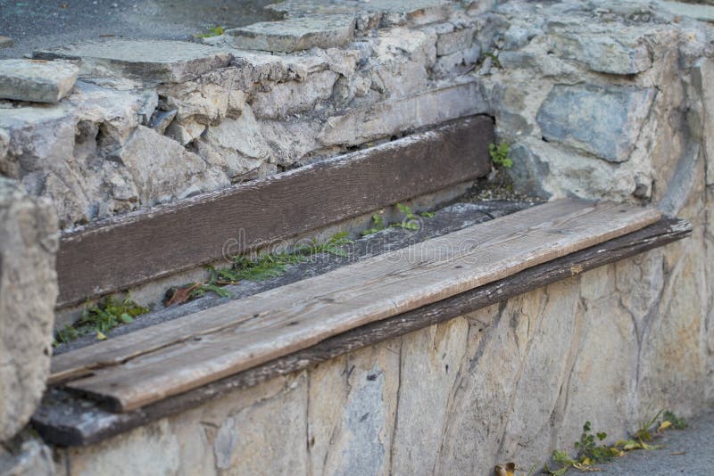 Wooden Bench in the Stone Wall Stock Image - Image of retro, concrete ...