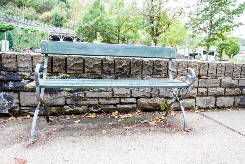 An wooden bench in street stock image. Image of nature - 79780789