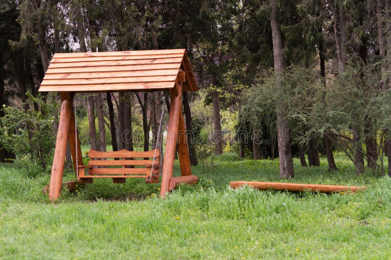 Wooden Bench Swing in the Park in Spring Stock Photo - Image of brown ...