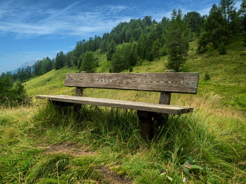 Wooden Bench Under the Hill with Grass and Trees Stock Photo - Image of ...