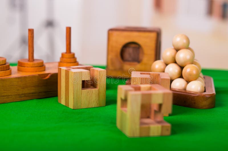 Wooden Block Brain Teaser Puzzle on Green Table in a Blurred Background ...