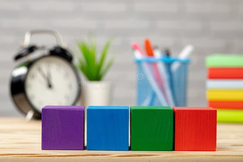 Wooden Blocks and Alarm Clock on Wooden Desk Stock Image - Image of ...