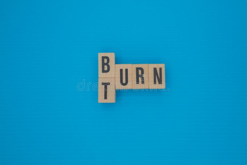 Wooden Blocks on Blue Background Forming the Words BURN and TURN ...