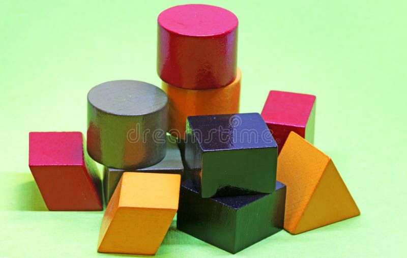 Wooden Blocks in Different Colors and Shapes on Green Background Stock ...