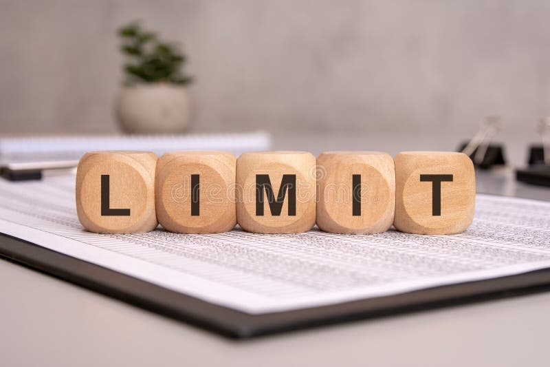 Wooden Blocks Spelling "LIMIT" on Financial Documents, Symbolizing ...