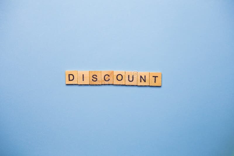 Wooden Blocks Spelling Out the Word DISCOUNT on a Light Blue Background ...