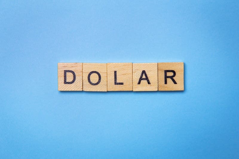 Wooden Blocks Spelling Out the Word DOLLAR on a Light Blue Background ...