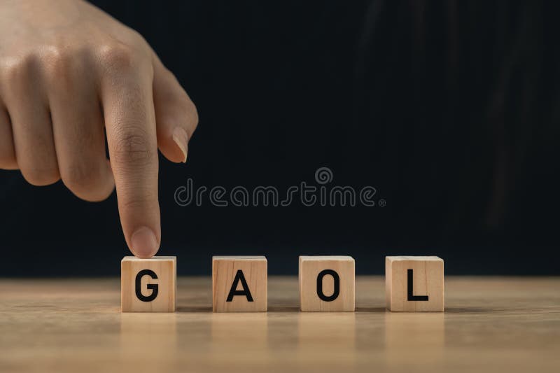 Wooden Blocks Spelling Out the Word GAOL with a Hand Pointing ...