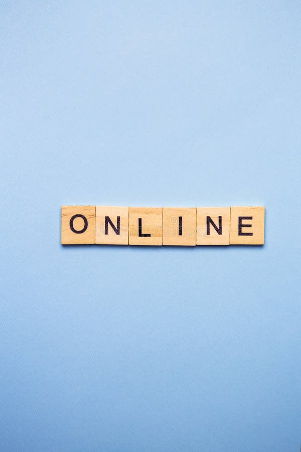 Wooden Blocks Spelling Out the Word ONLINE on a Light Blue Background ...