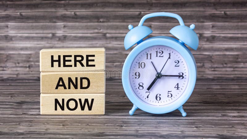 Wooden Blocks with Text HERE and NOW on Wooden Table with Clock Stock ...