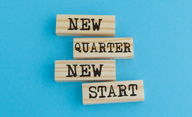 On Wooden Blocks the Text NEW QUARTER, NEW START on Blue Background ...