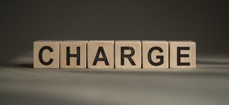 A Wooden Blocks with the Word CHARGE Written on it on a Gray Background ...