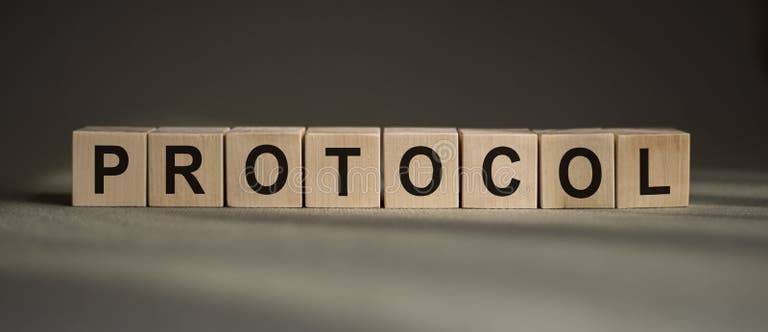 A Wooden Blocks with the Word PROTOCOL Written on it on a Gray ...