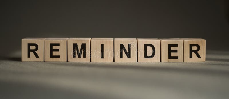 A Wooden Blocks with the Word REMINDER Written on it on a Gray ...