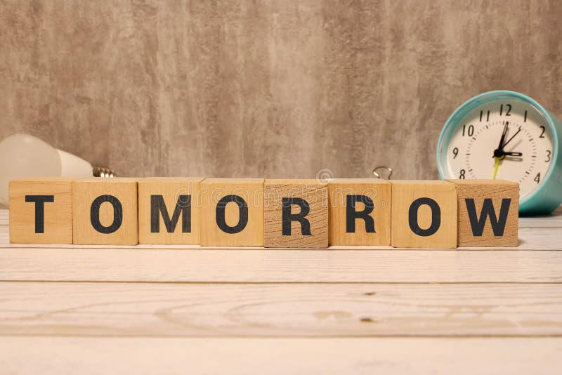A Wooden Blocks with the Word TOMORROW Written on it on a Gray ...