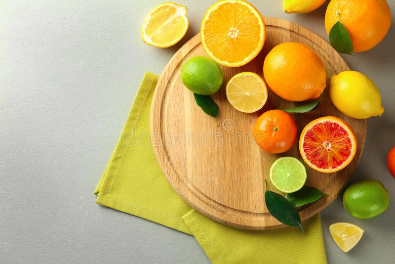 Wooden Board with Different Citrus Fruits on Table, Top View Stock ...