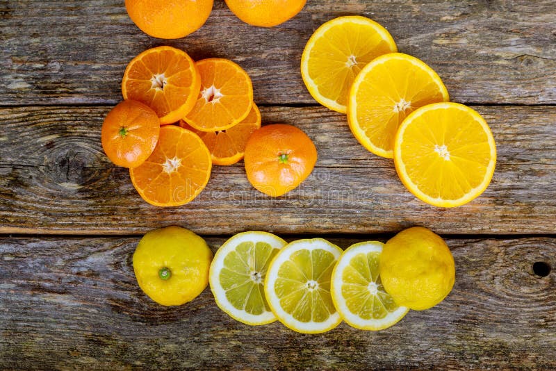 Wooden Board with Different Citrus Fruits on Table, Top View Stock ...