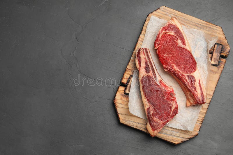 Wooden Board with Raw Beef Meat on Black Table. Space for Text Stock ...