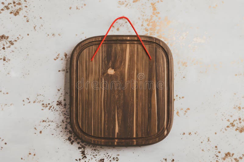 Wooden Board with a Red String Loop Adorned with Subtle Gold Specks ...