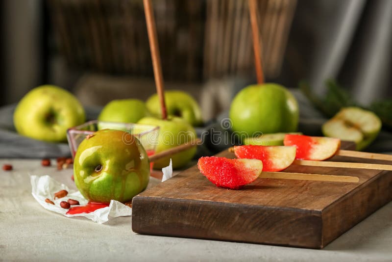 Wooden Board with Tasty Candy Apples on Light Table Stock Photo - Image ...