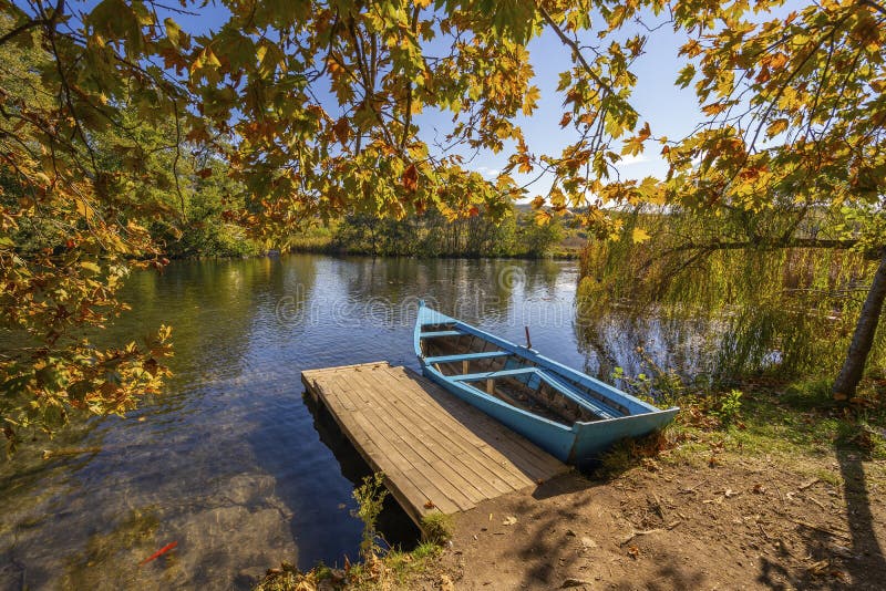 Wooden Boat at Pier on Beautiful Lake Stock Image - Image of trip ...