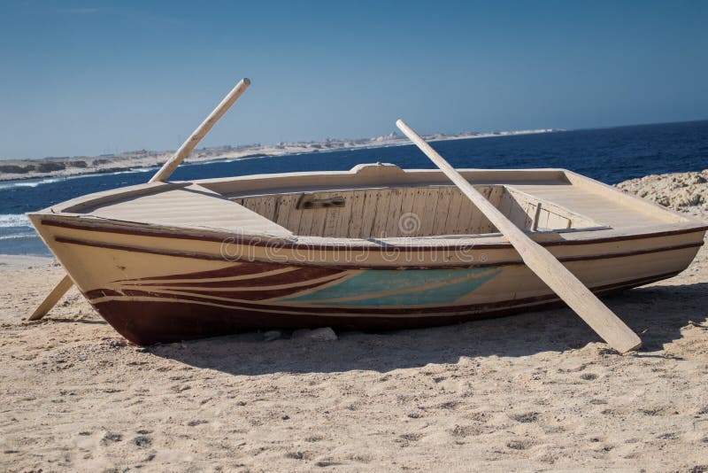 Wooden Boat with Two Oars on Beach Stock Photo - Image of nautical ...