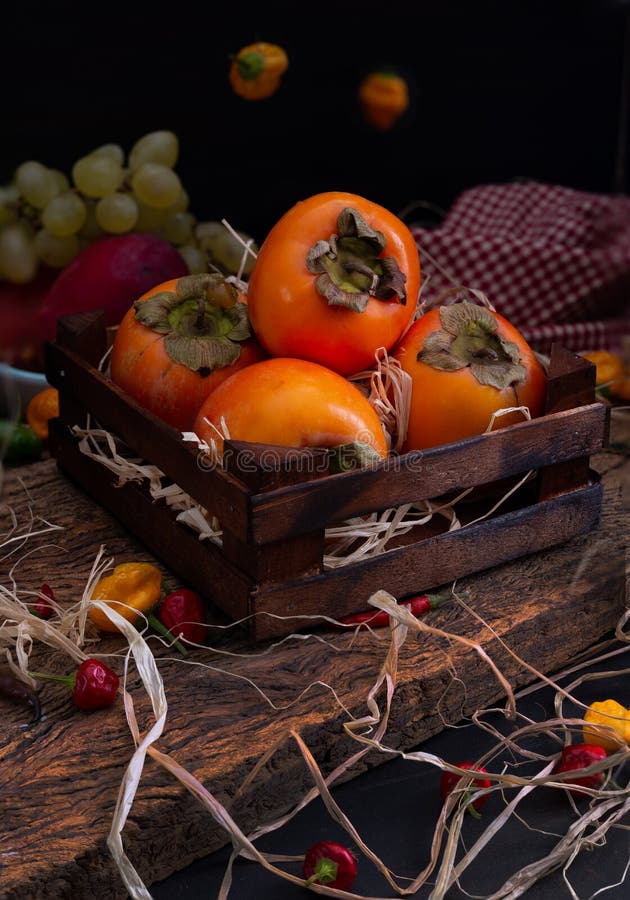Wooden box with persimmon stock photo. Image of healthy - 258130444