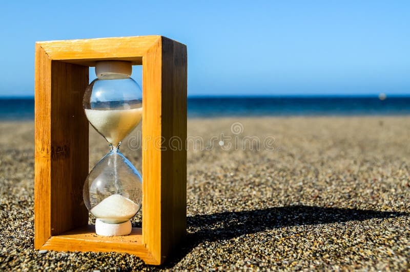 A Wooden Box with a Sand Timer on the Beach Stock Image - Image of ...