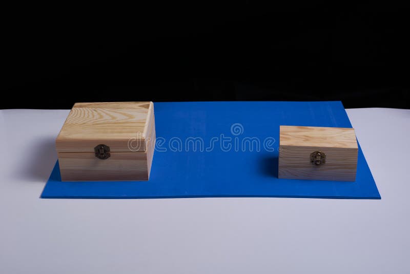 Wooden Boxes on Black Background and Blue Mat Stock Photo - Image of ...