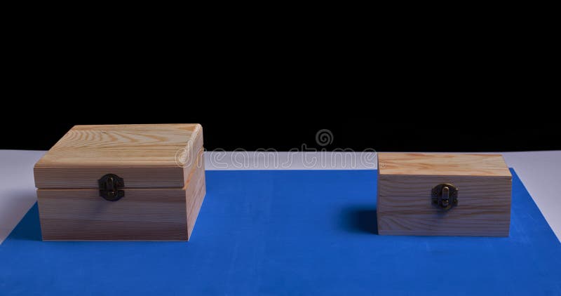 Wooden Boxes on Black Background and Blue Mat Stock Photo - Image of ...