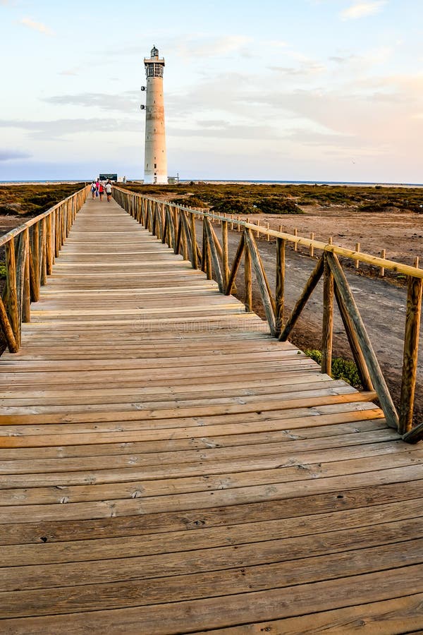 A Wooden Bridge Leads To a Lighthouse Stock Image - Image of road, path ...