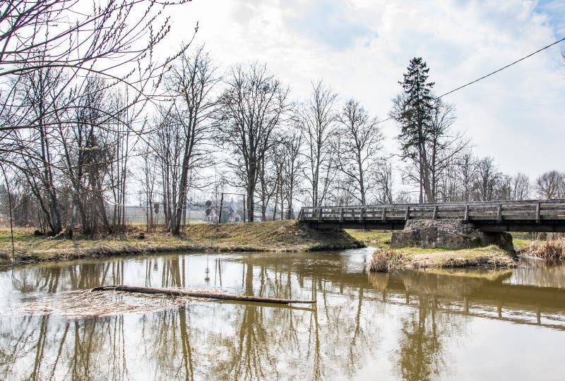 Spring Landscape. a Wooden Bridge Over a Small River in Early Spring ...