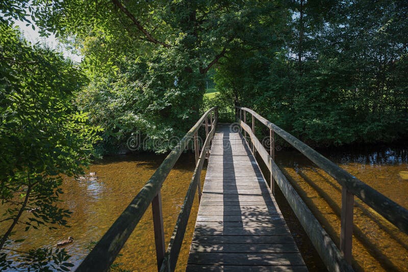 Wooden Bridge Over a Small River Stock Image - Image of branches, pass ...
