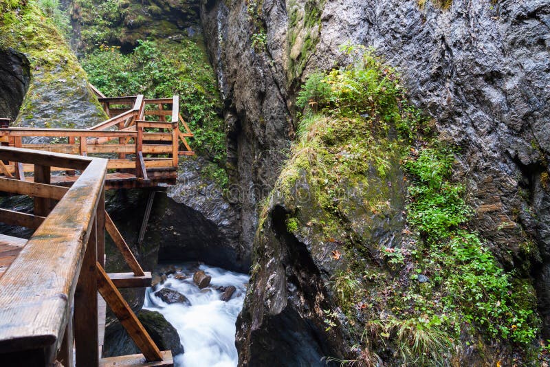 A Wooden Bridge Over a Stormy River Stock Photo - Image of flowing ...