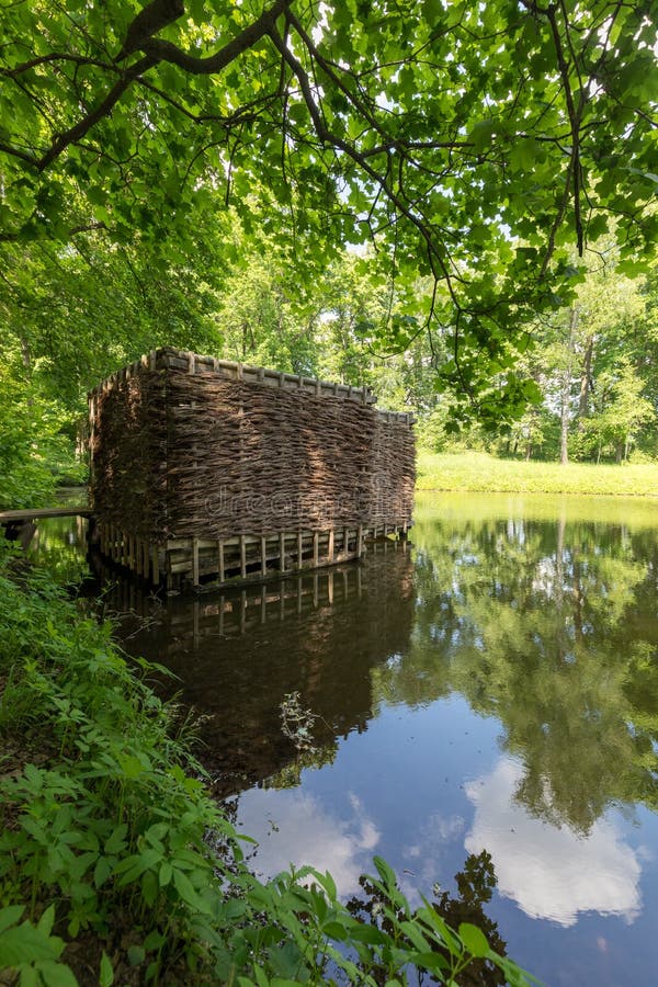 Wooden Building on the Shore of the Pond. Wicker Building in the Forest ...