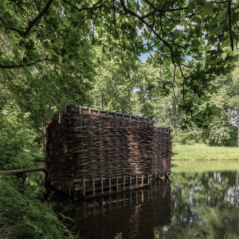 Wooden Building on the Shore of the Pond. Wicker Building in the Forest ...