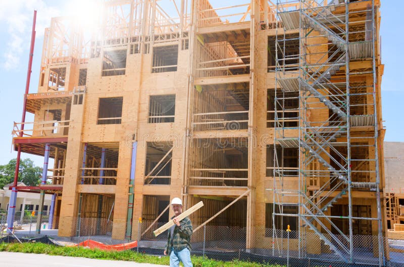 Wooden Building Under Construction with Worker Stock Photo - Image of ...