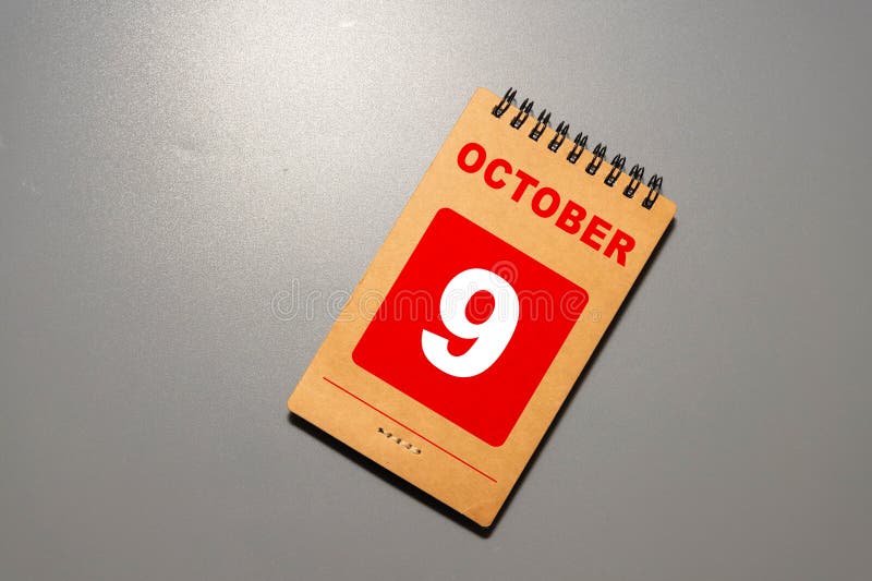 Wooden Calendar with the Date October 09 on a Desktop with a Laptop ...